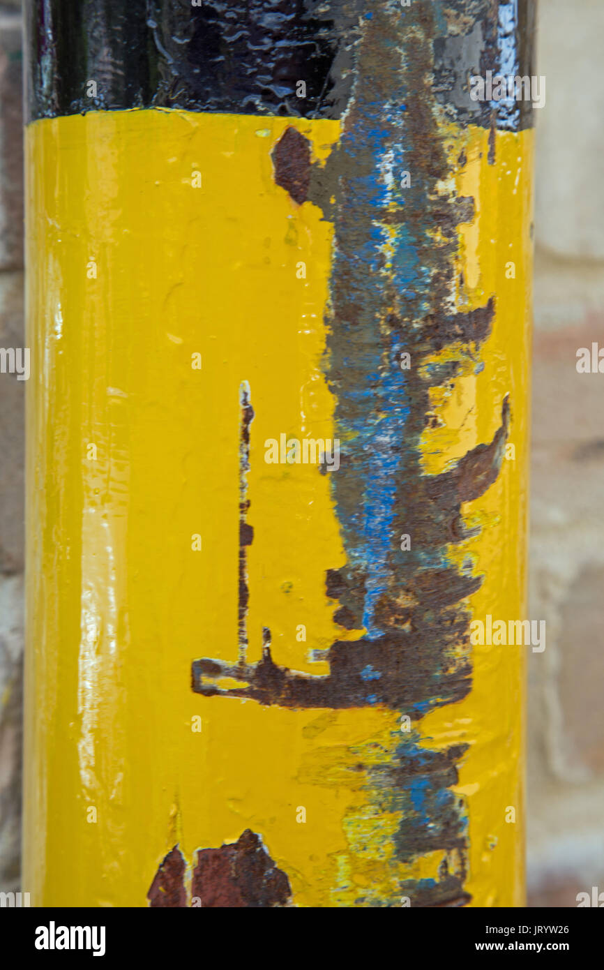 Accident damaged yellow car park post Stock Photo - Alamy