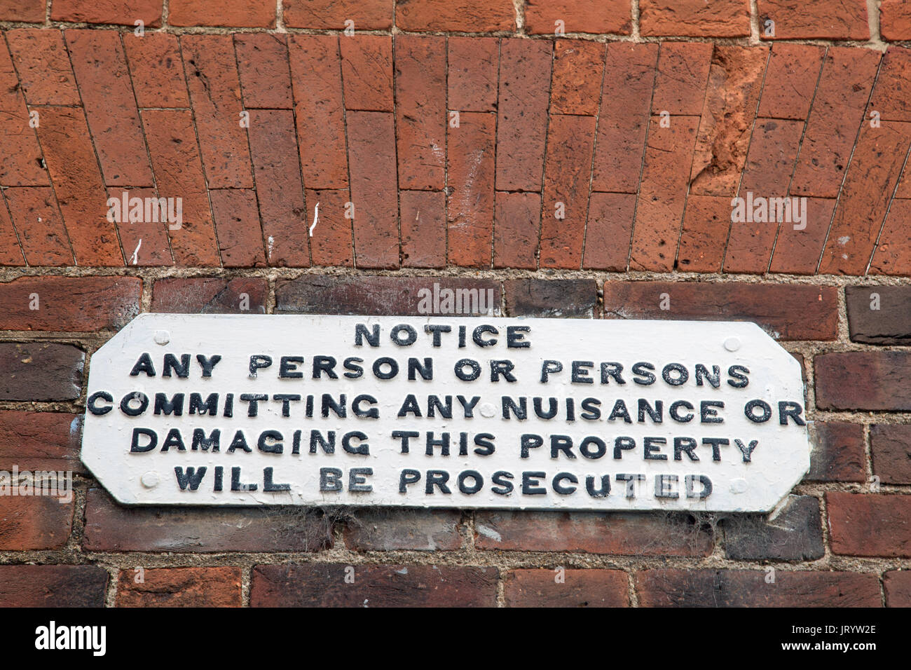 Vintage black and white warning notice on a red brick wall Stock Photo ...