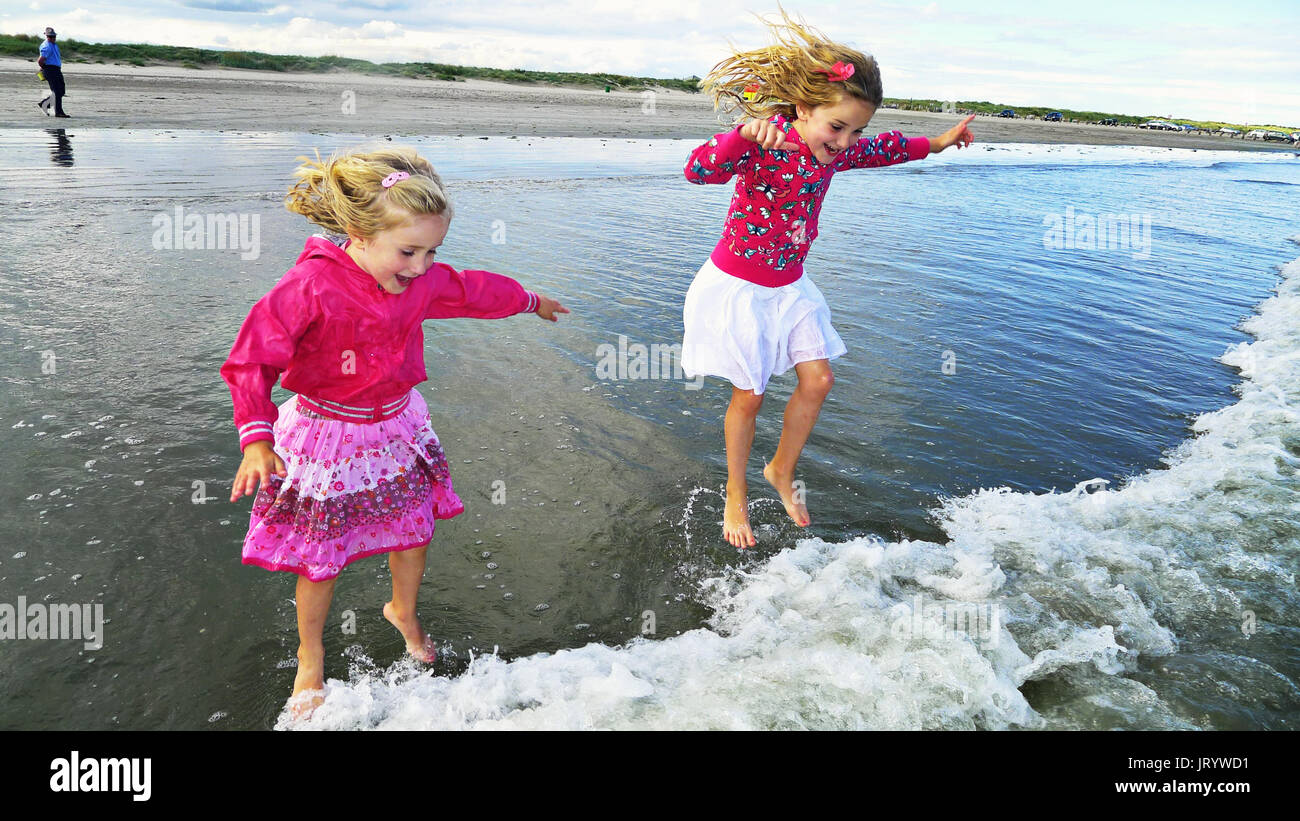 Children jumping over waves hi-res stock photography and images - Alamy
