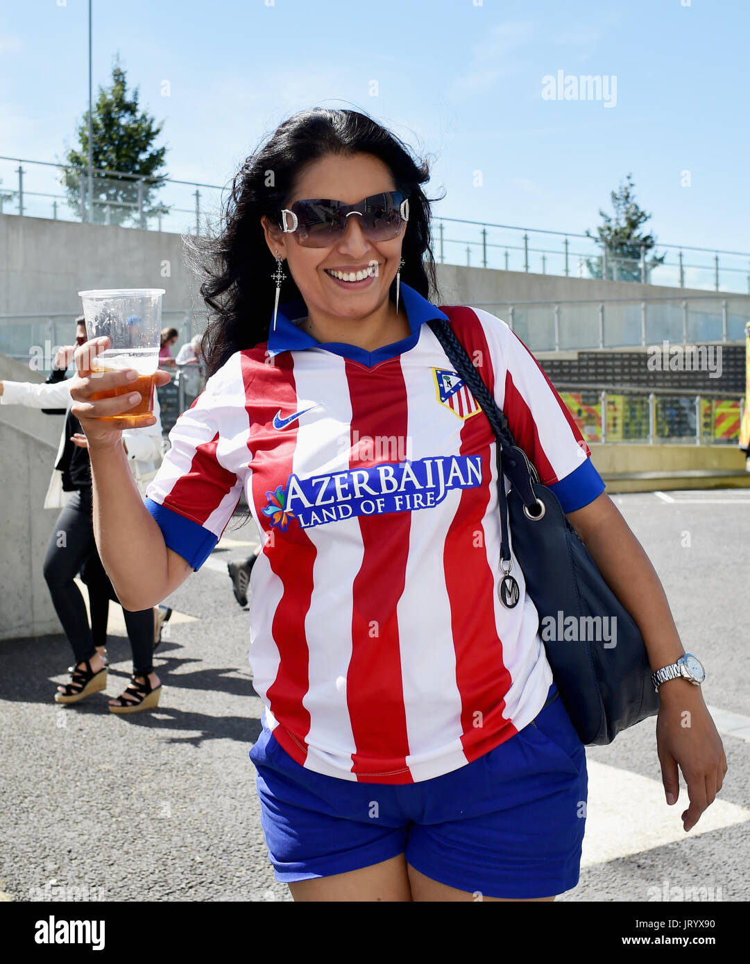 Female Atletico fan with plastic glass of beer during the friendly ...