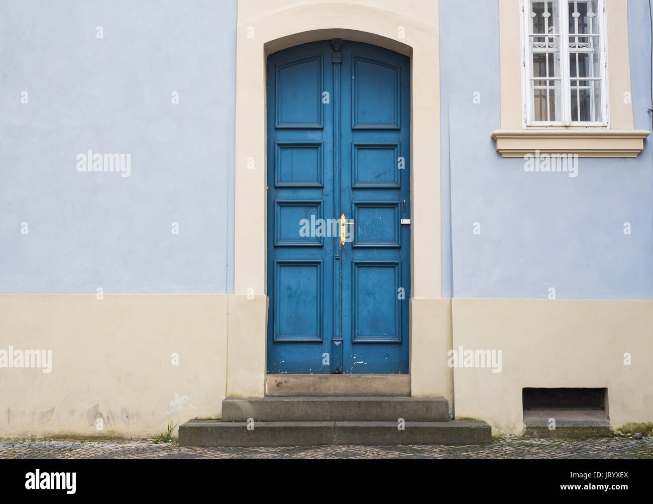 A front entrance of a home with blue door Stock Photo - Alamy