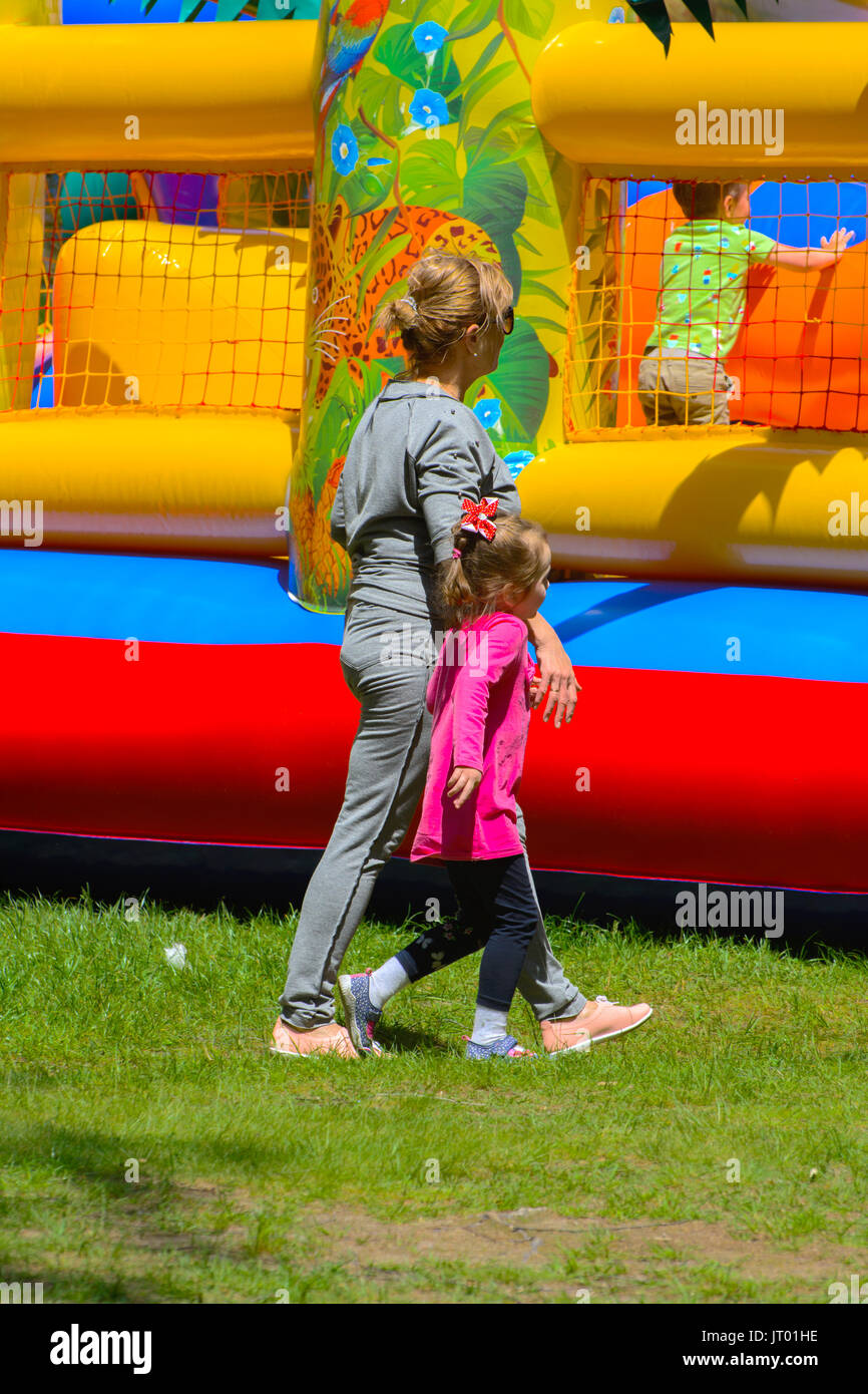 Children play on the inflatable children's playground in the city park ...