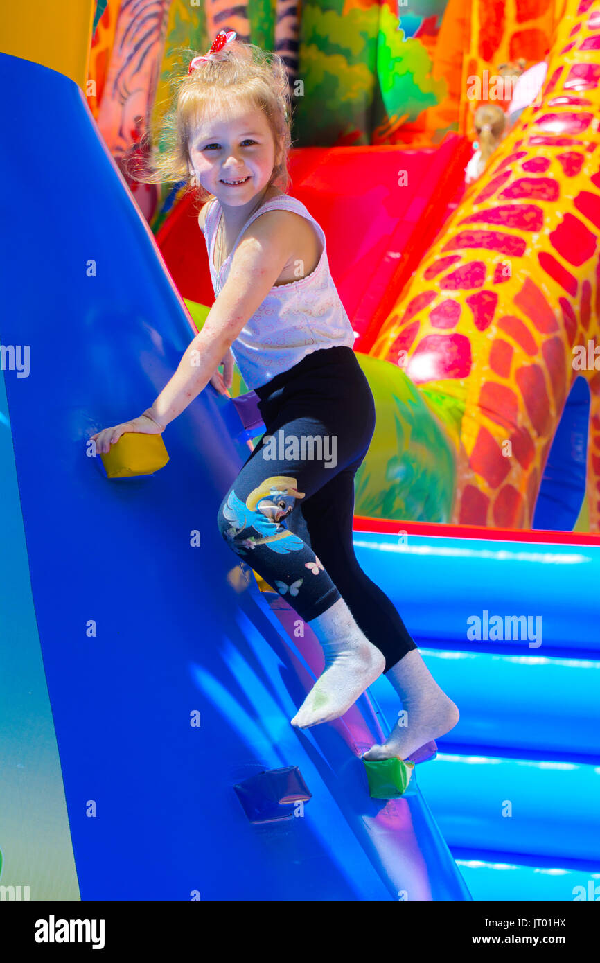 Children play on the inflatable children's playground in the city park ...