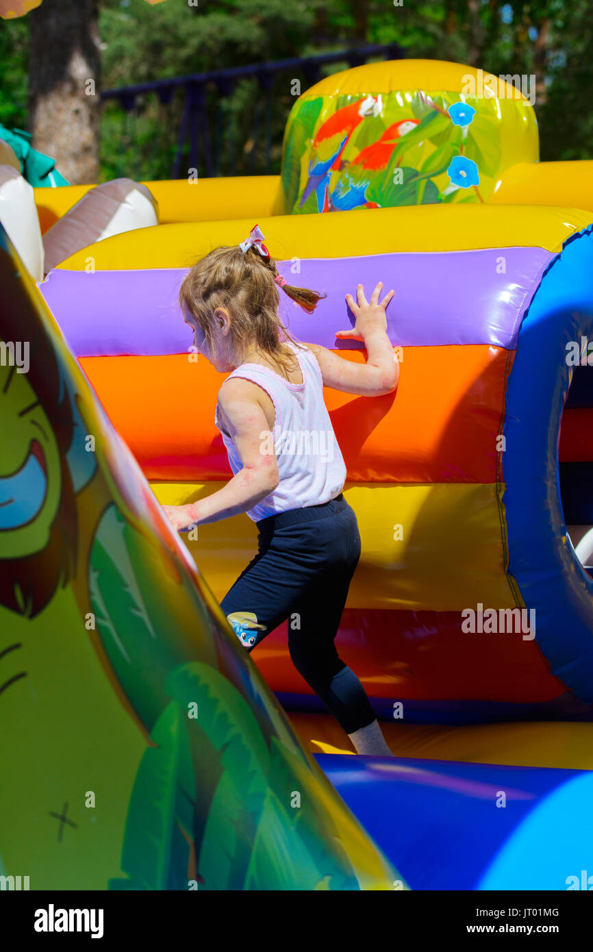 Children play on the inflatable children's playground in the city park ...