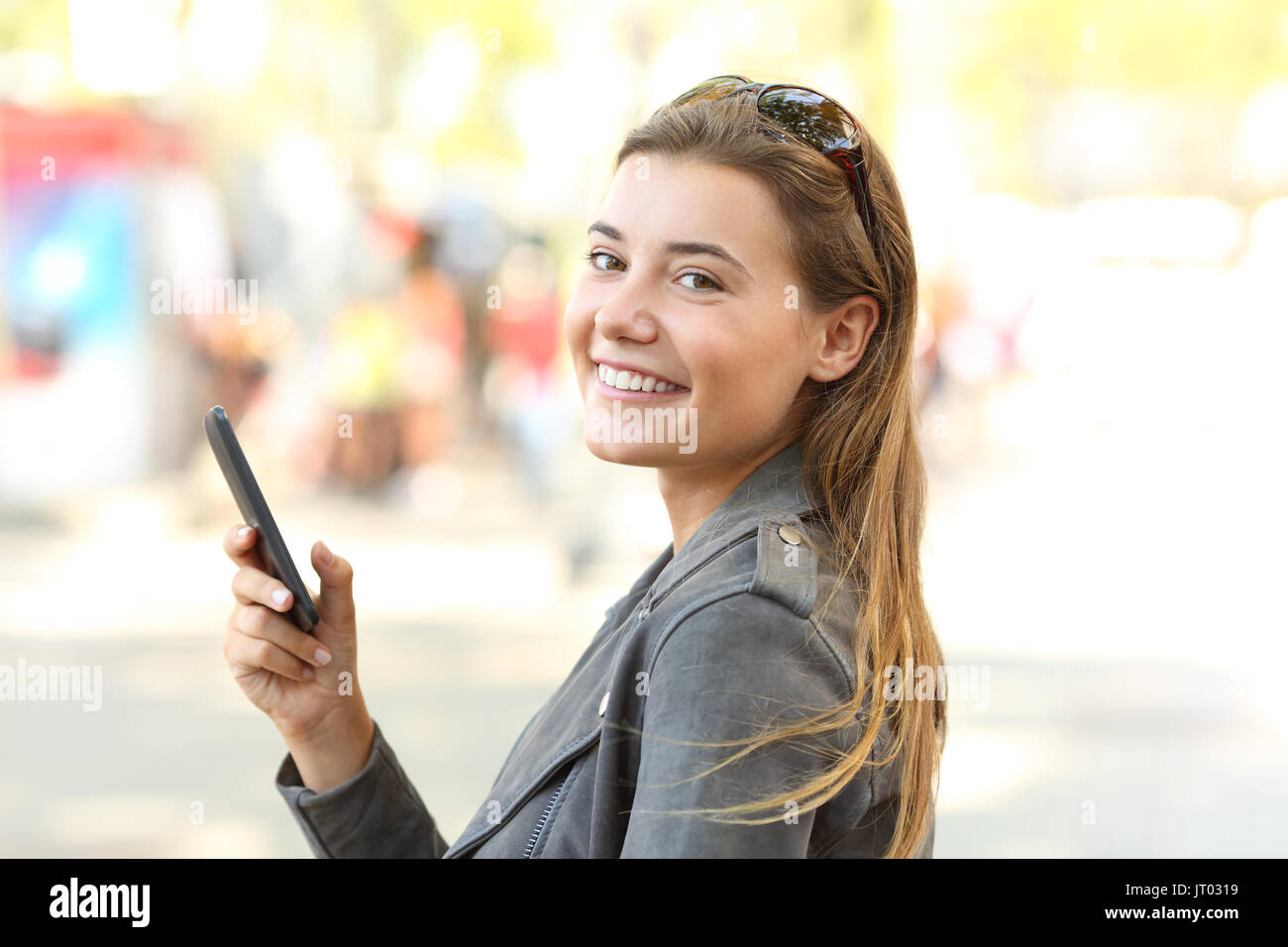 Teen girl walking alone cell phone hi-res stock photography and images ...