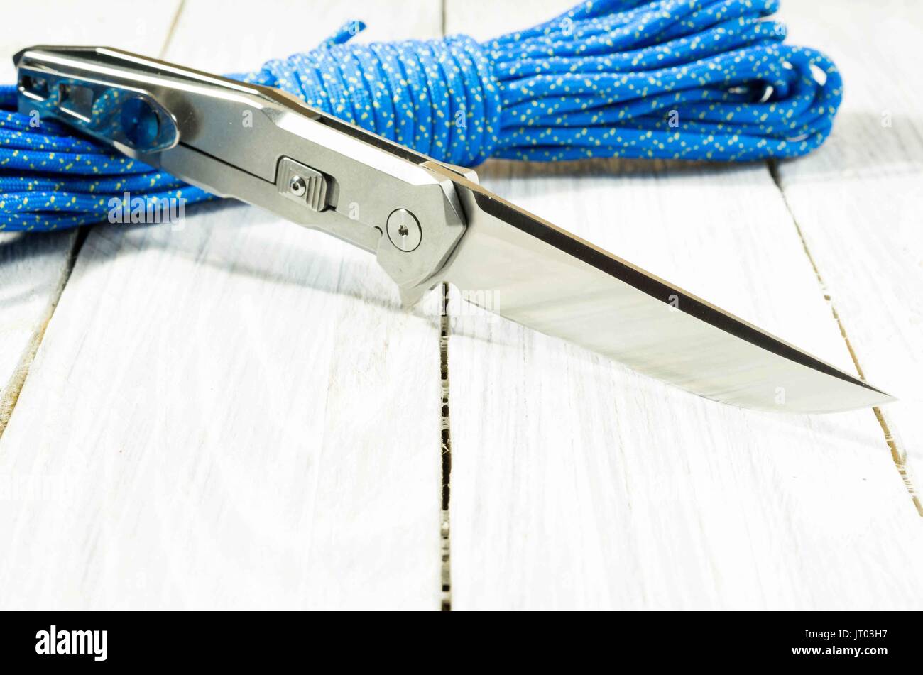 The knife blade is like a mirror. A metal knife. The cord is blue ...