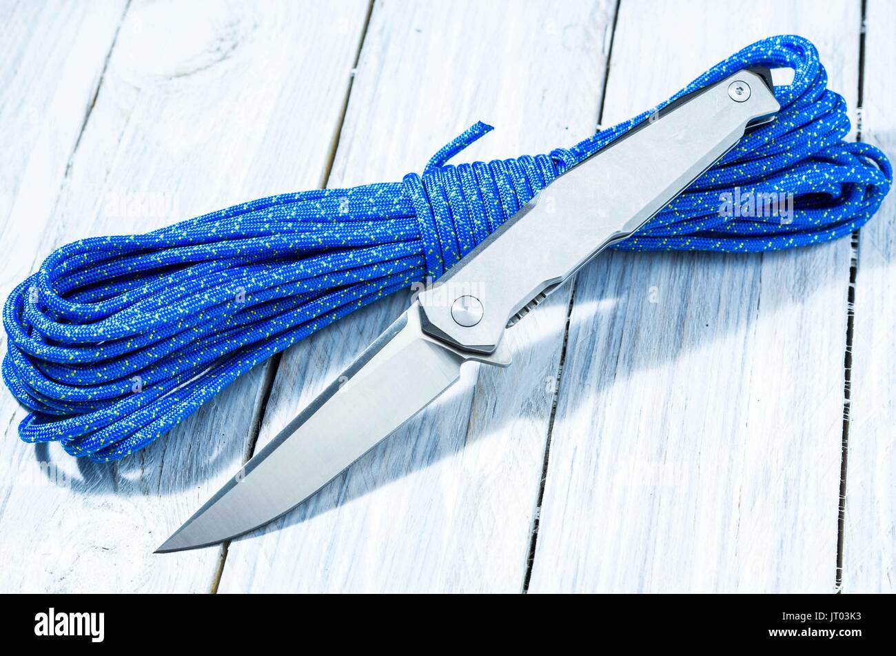 A shiny knife on a parachute cord. Front side. White knife on white ...