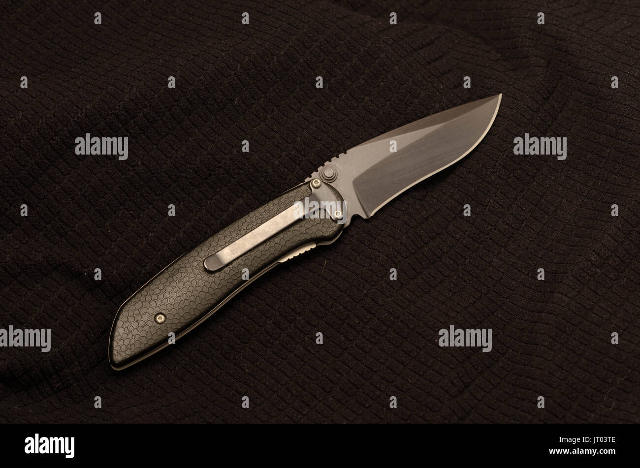 Black knife on a black background. Back view. Black on black Stock ...