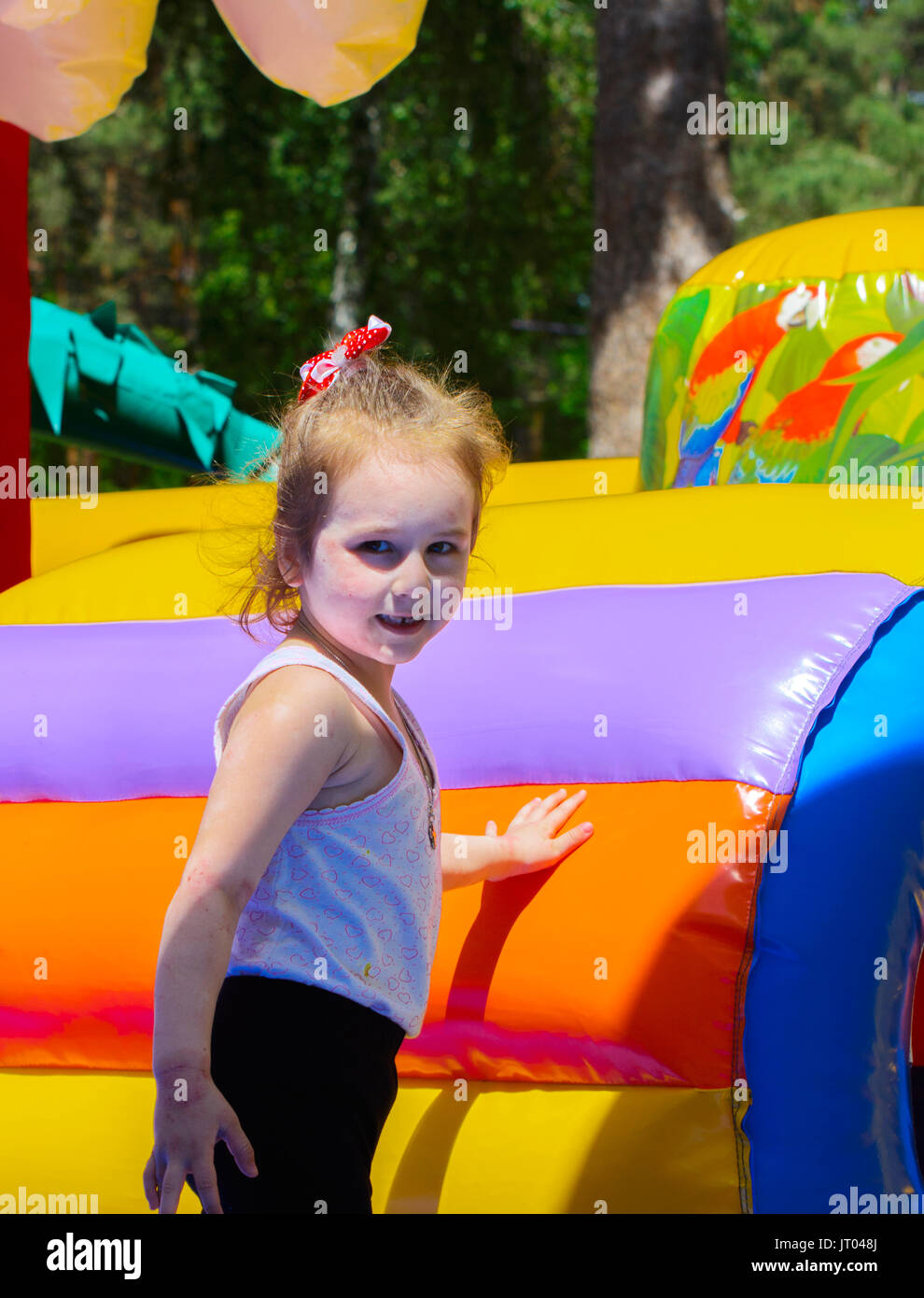 Children play on the inflatable children's playground in the city park ...