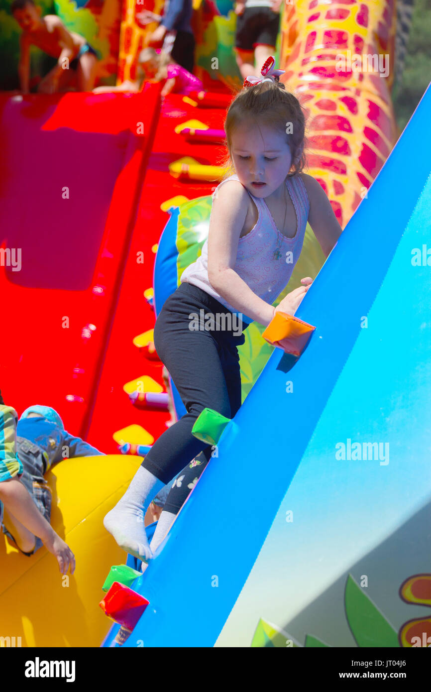 Children play on the inflatable children's playground in the city park ...