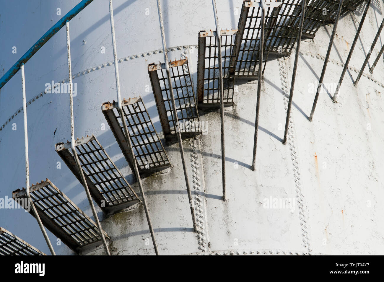 Gasoline storage tank with staircase along side creating patterns Stock ...