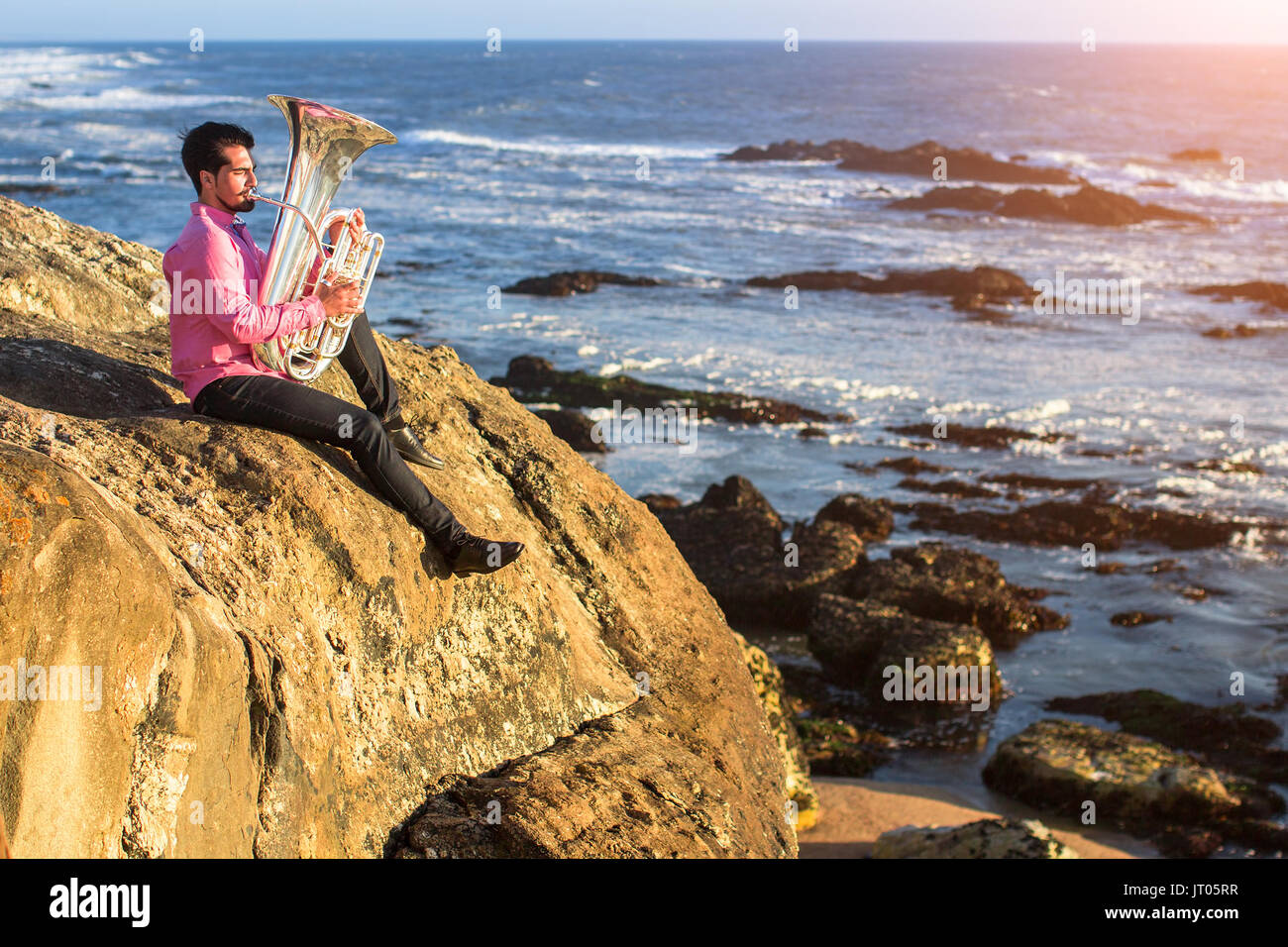 Musician play Tuba musical instrument on sea shore outdoor Stock Photo ...