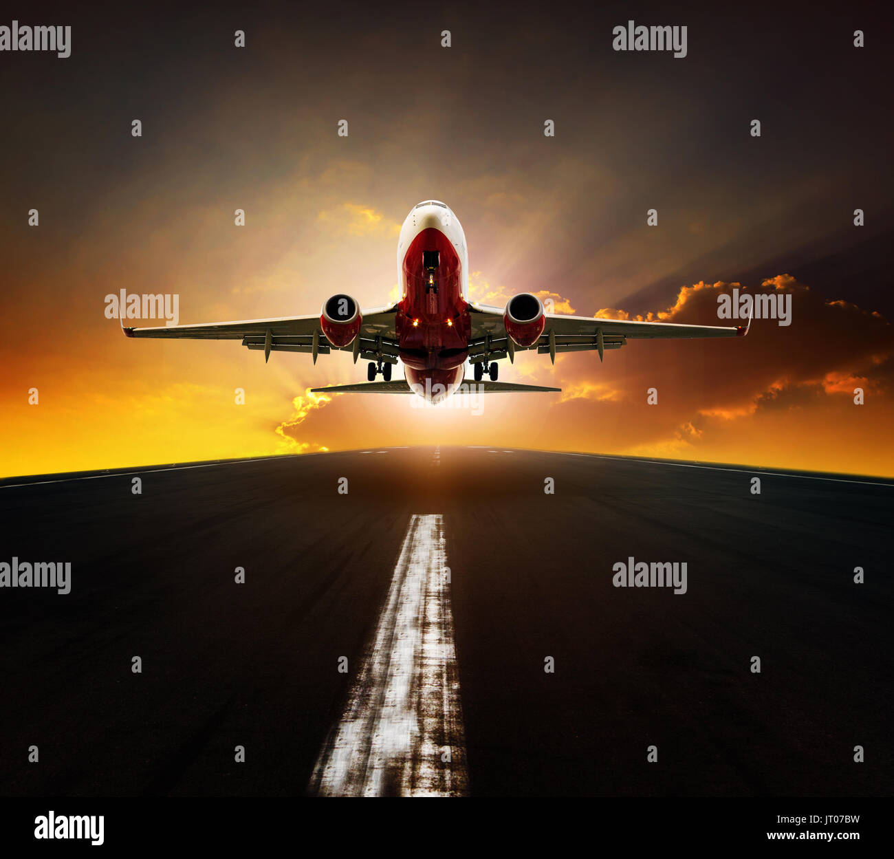 passenger plane take off from airport runway agasint beautiful sun ...