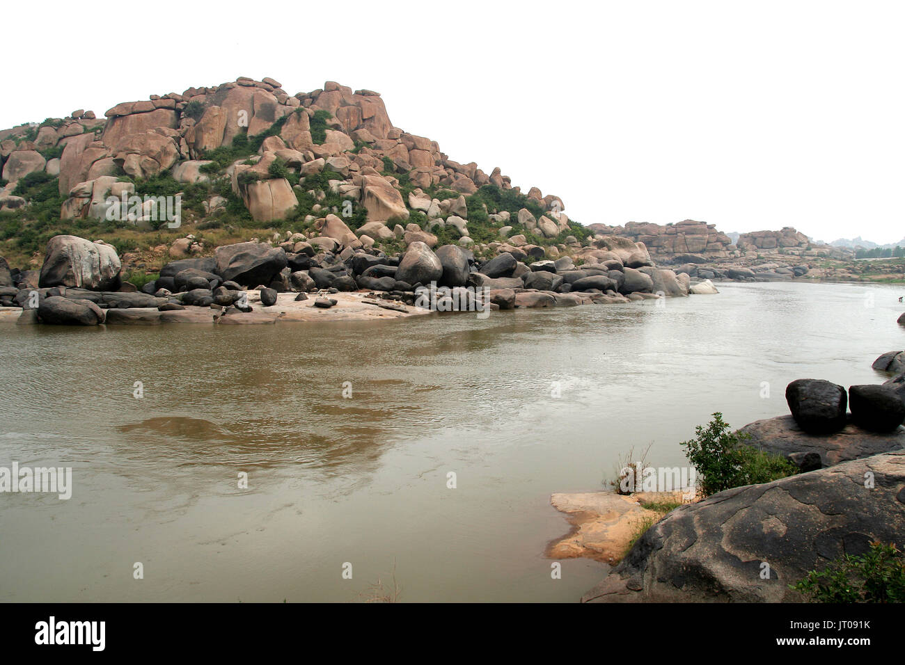 View of Tungabhadra River flowing in between rocky hills at Hampi ...