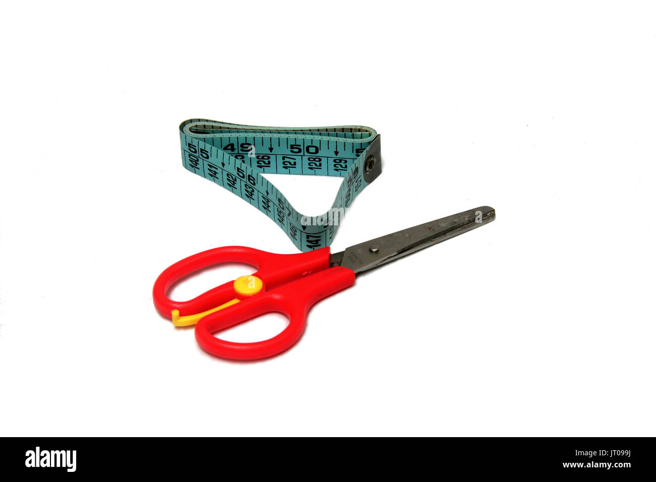 Measuring tape and scissors used in tailoring work Stock Photo - Alamy