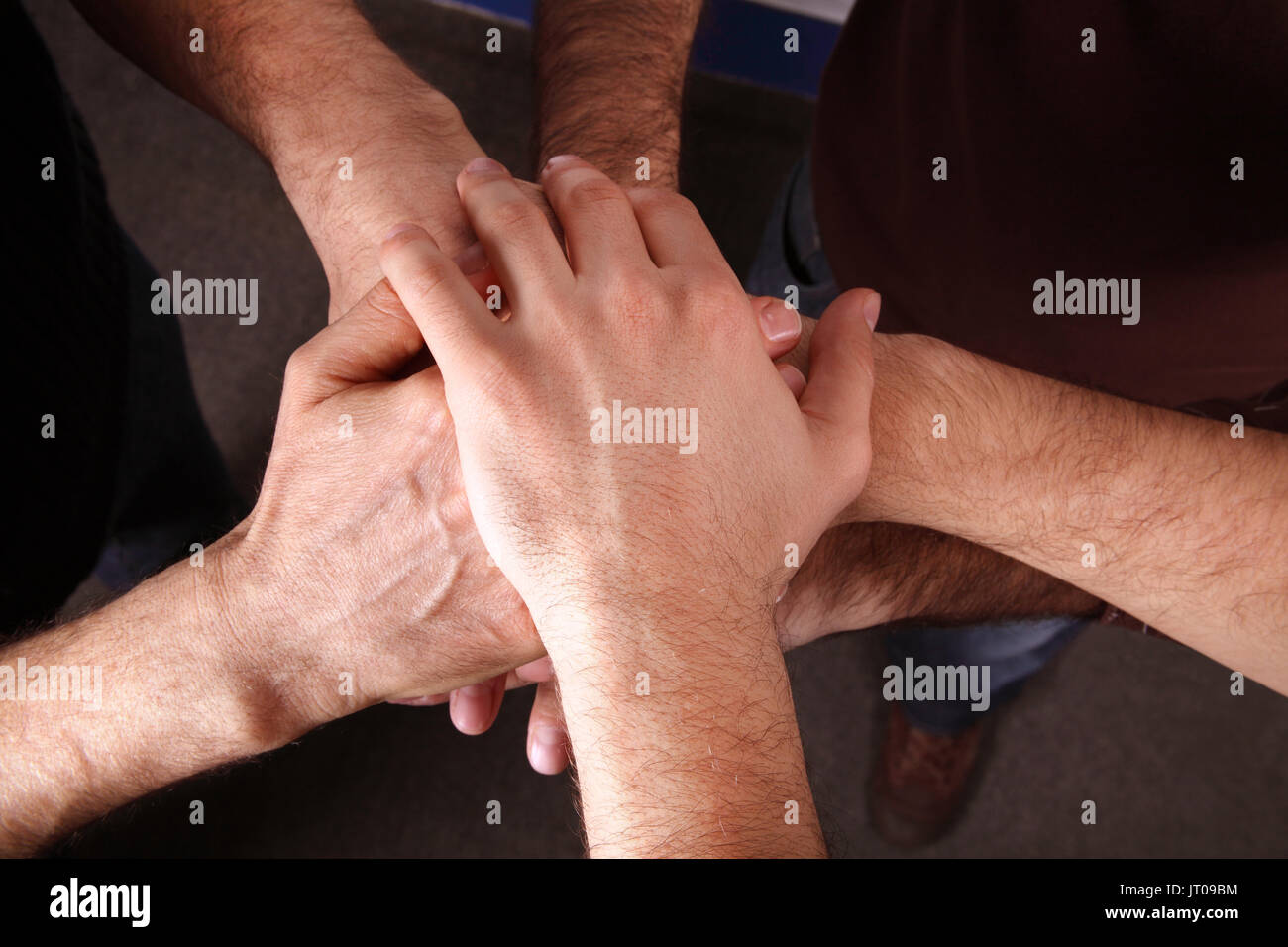 an image of hands clasped showing determination Stock Photo - Alamy