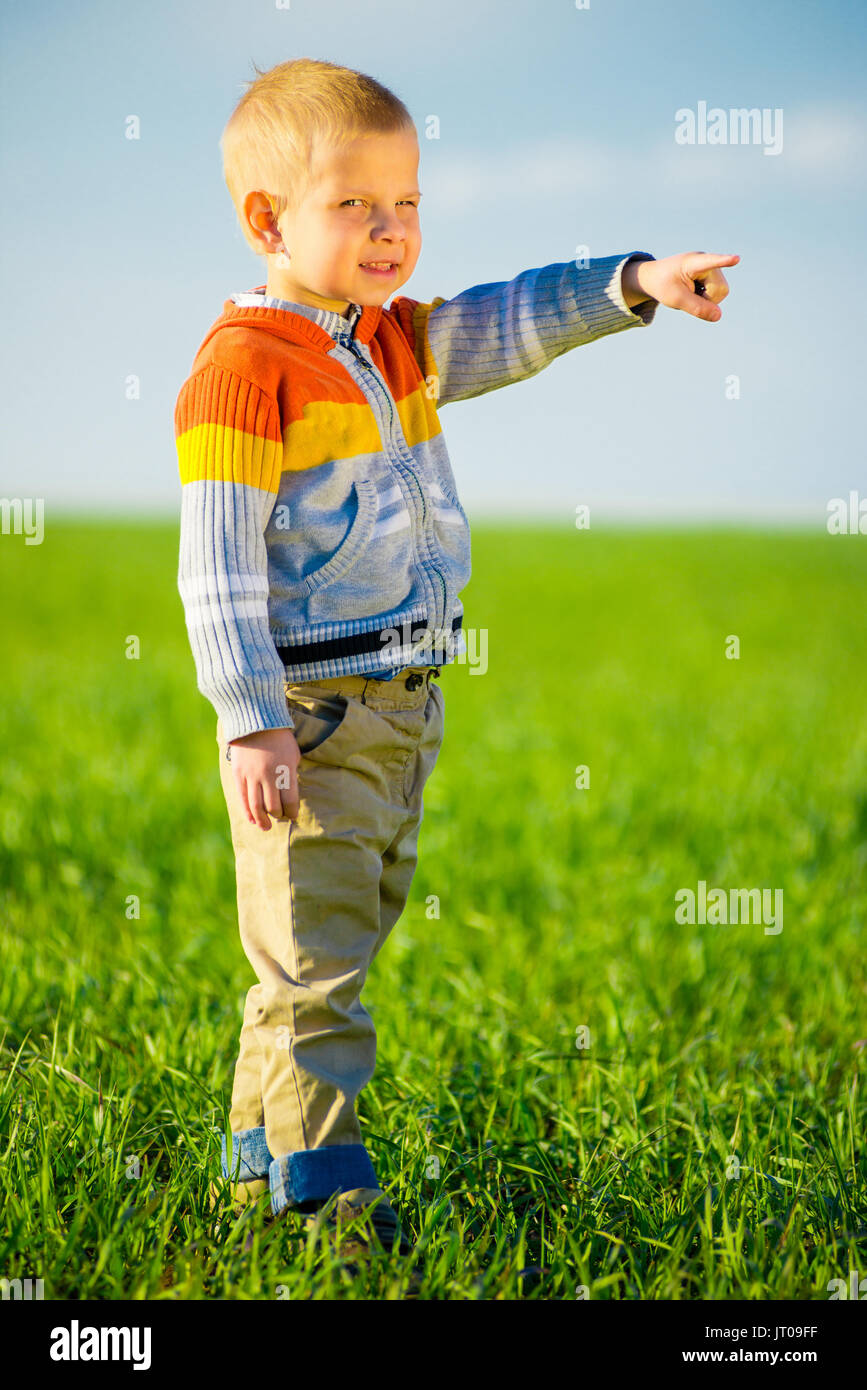 Boy pointing back view hi-res stock photography and images - Alamy