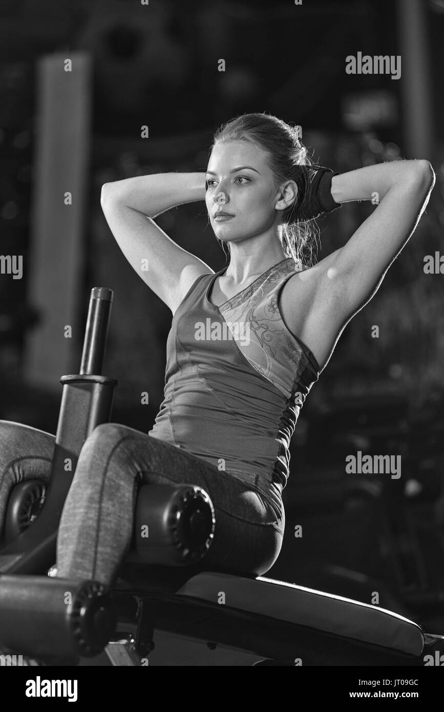 Woman doing strength exercises for abdominal muscles at indoor sport ...