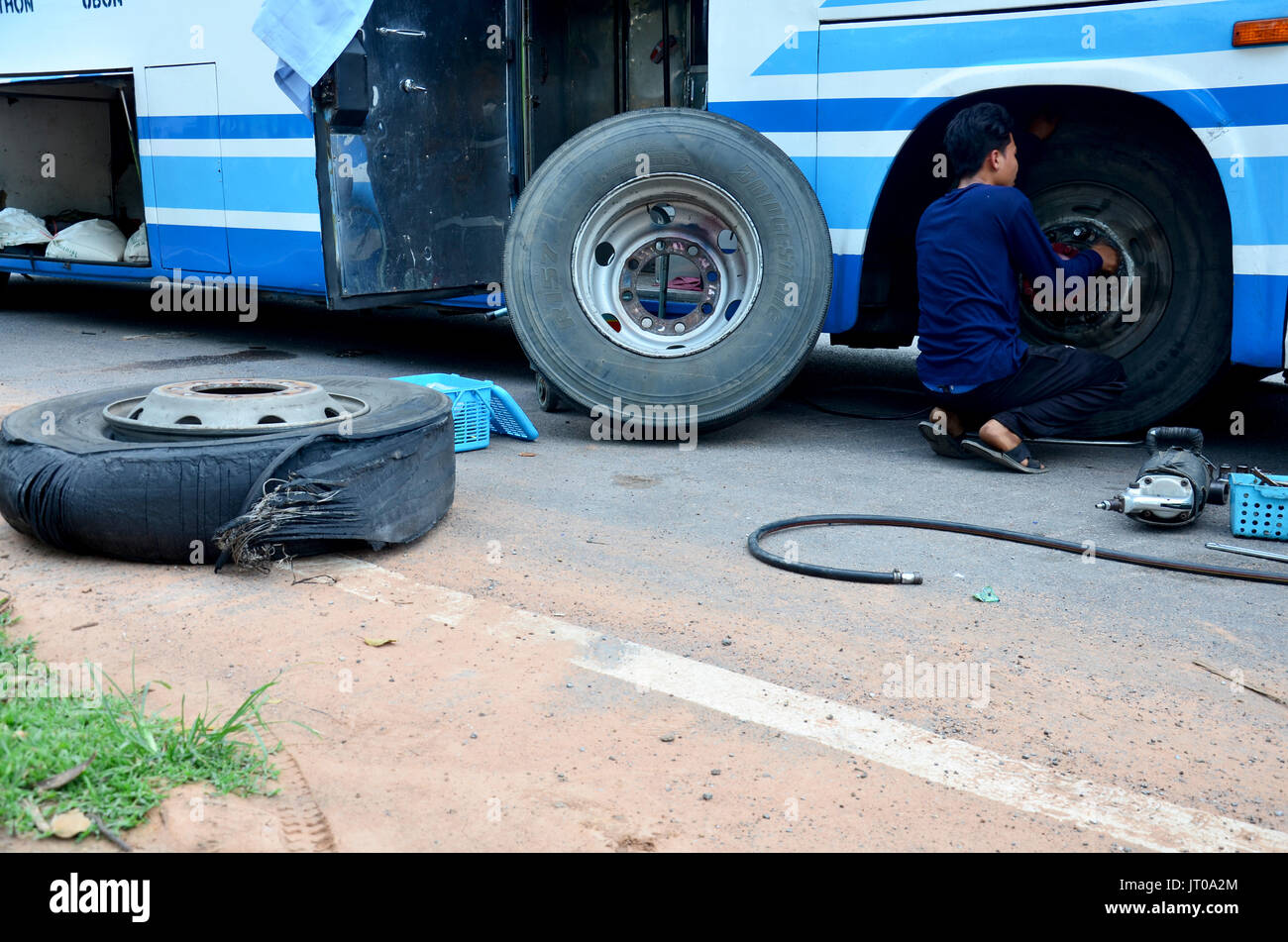 Thai mechanic people repairing and fix change wheel tire of bus broken ...