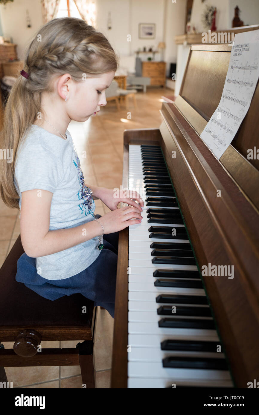 Girl is playing the piano hi-res stock photography and images - Alamy