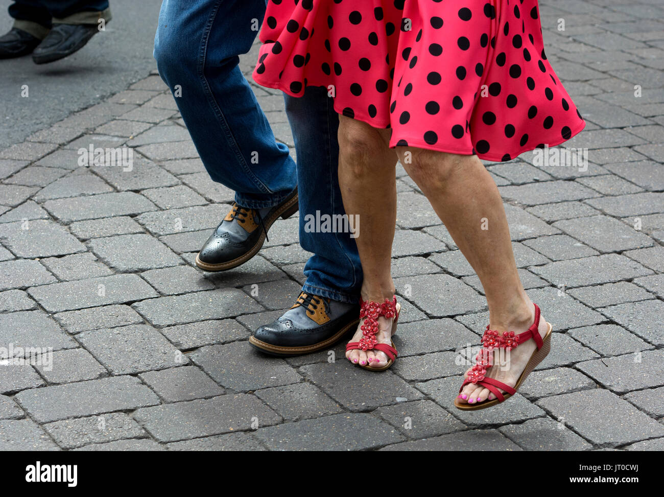 A couple jiving in the street Stock Photo - Alamy