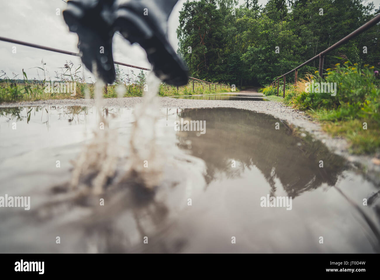 close-up of young woman's legs with rubber boots jumping and dancing in ...