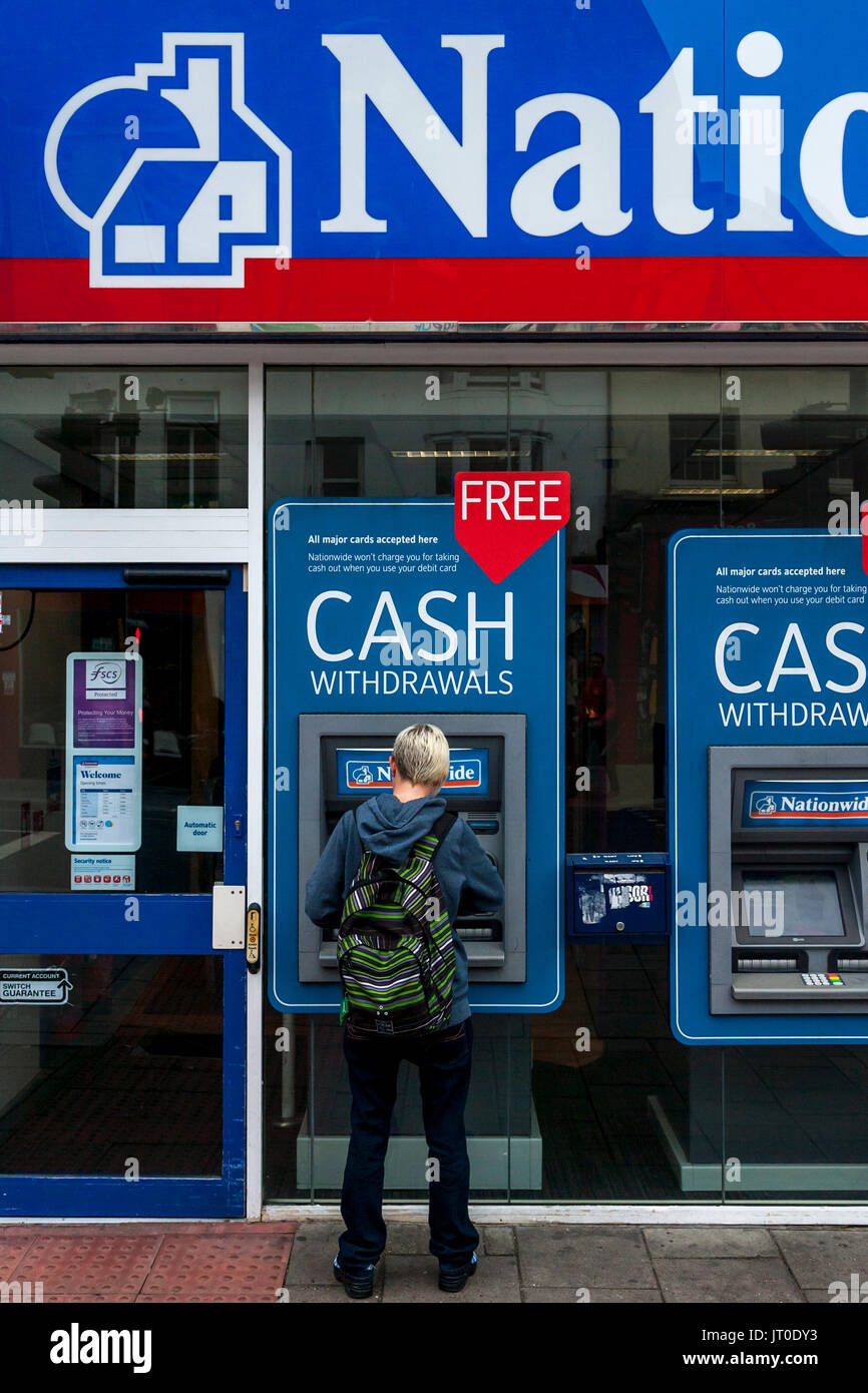 Woman withdrawing cash hi-res stock photography and images - Alamy