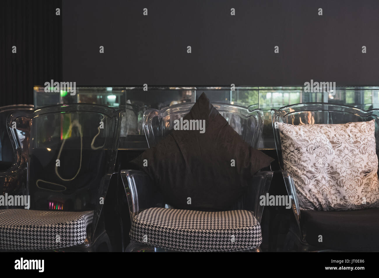 transparent plastic chair with black and white cushion and fabric ...