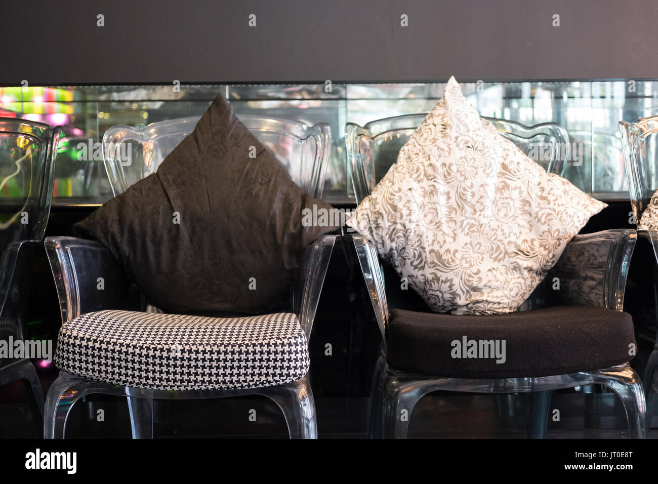 transparent plastic chair with black and white cushion and fabric ...