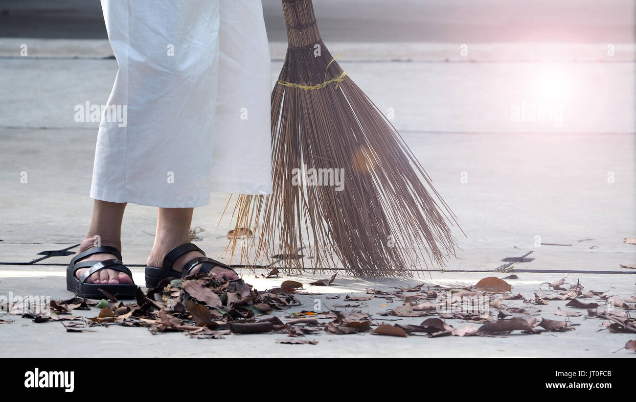Woman sweeping garden hi-res stock photography and images - Alamy