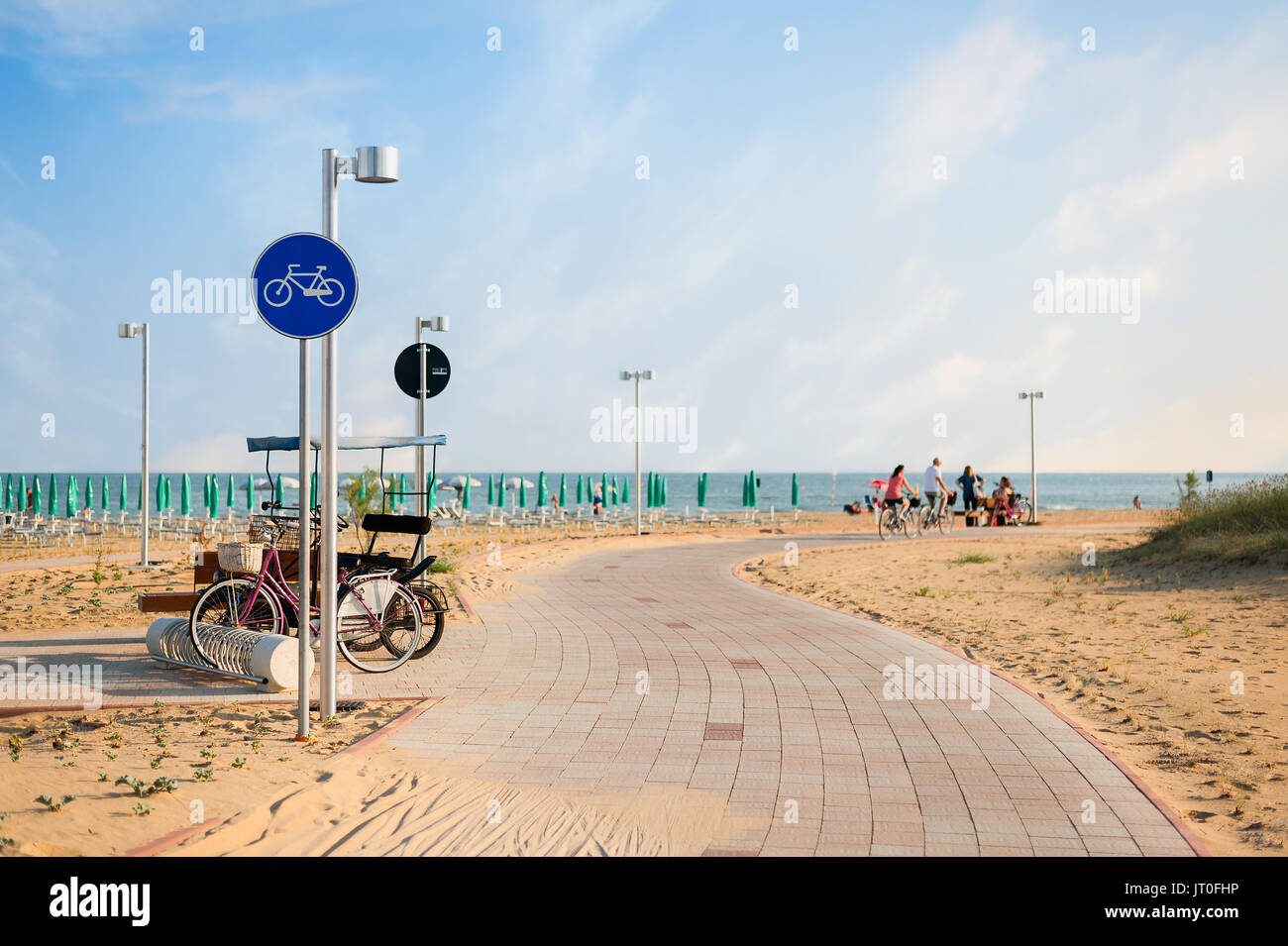 Cycling path with signal near beach on blue sky Stock Photo - Alamy