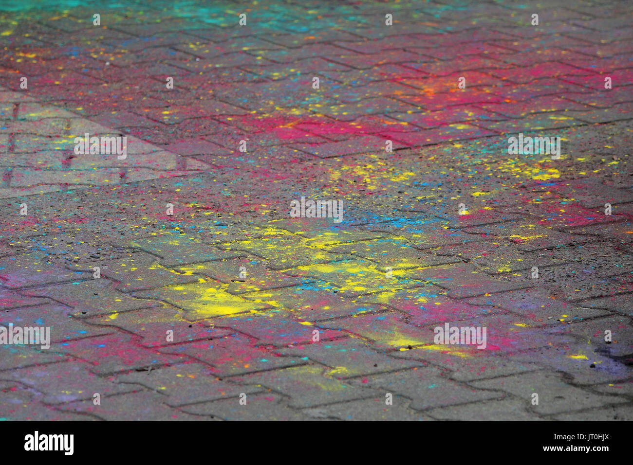 Multi-colored earth, paving slabs, powder coated with dry colors at the ...