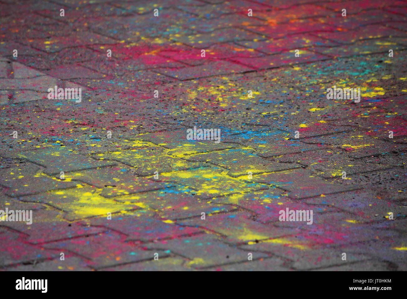 Multi-colored earth, paving slabs, powder coated with dry colors at the ...