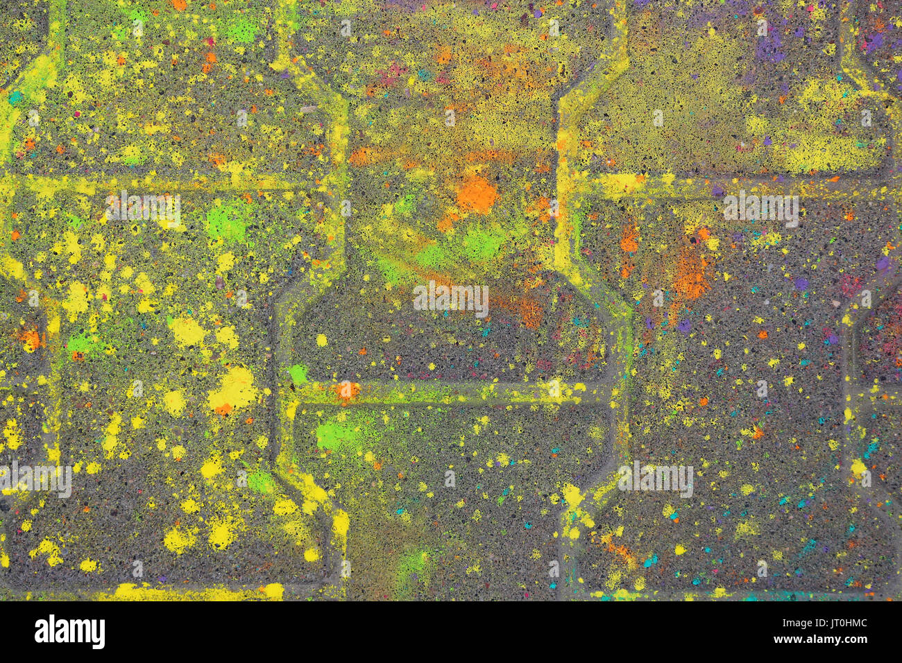 Multi-colored earth, paving slabs, powder coated with dry colors at the ...