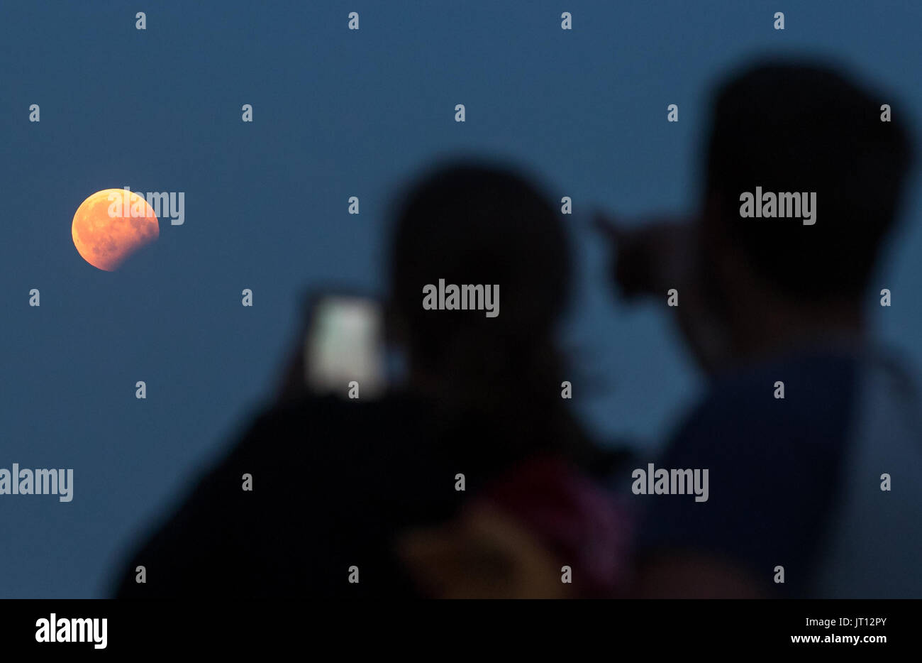 Berlin, Germany. 07th Aug, 2017. Glance at a partial moon eclipse in Berlin, Germany, 07 August ...