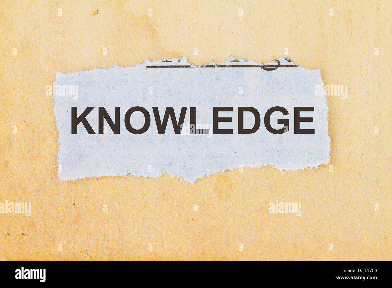 Knowledge newspaper cutout in an old paper background Stock Photo - Alamy