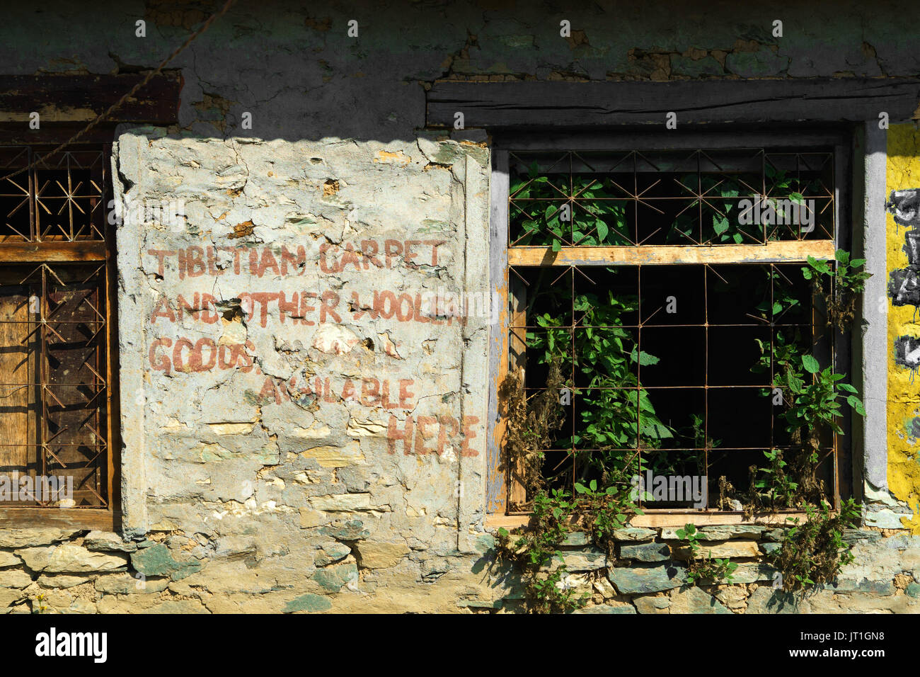 Hand written advert for woolen goods on the exterior wall of an ...