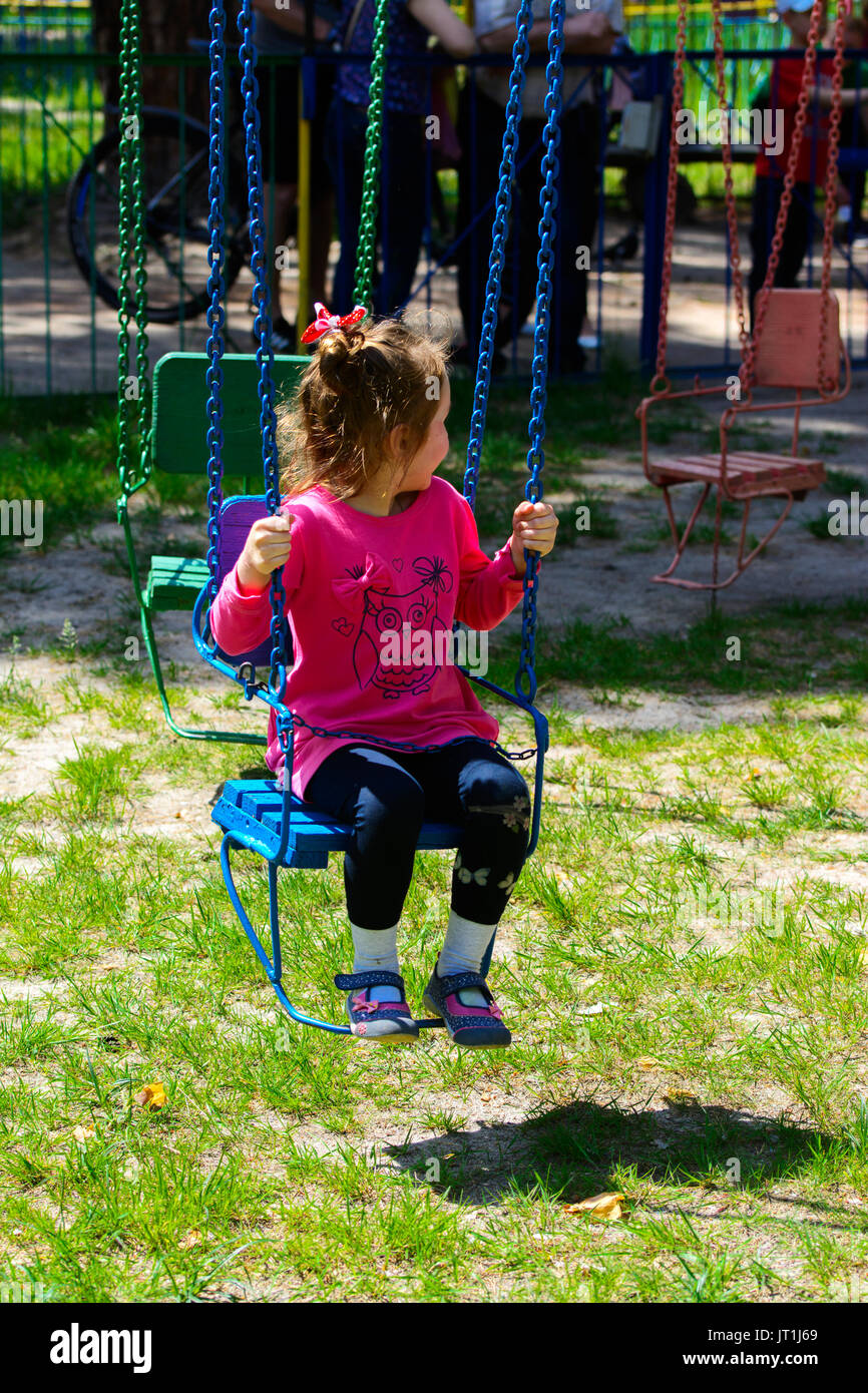 Children ride on the carousel on the children's playground in the city ...