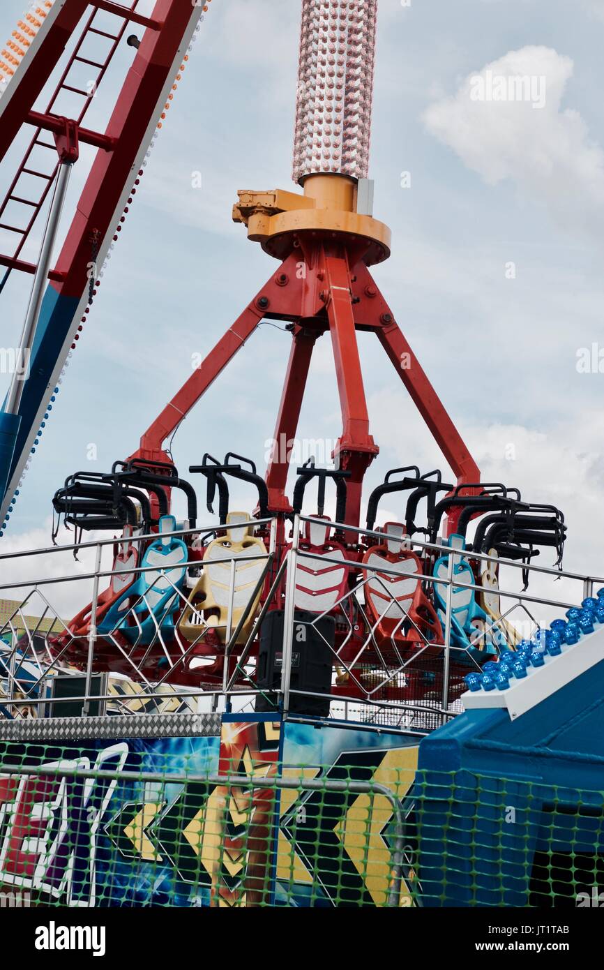 Colorful carousel in amusement park. Sunny sunday in Milton Keynes ...
