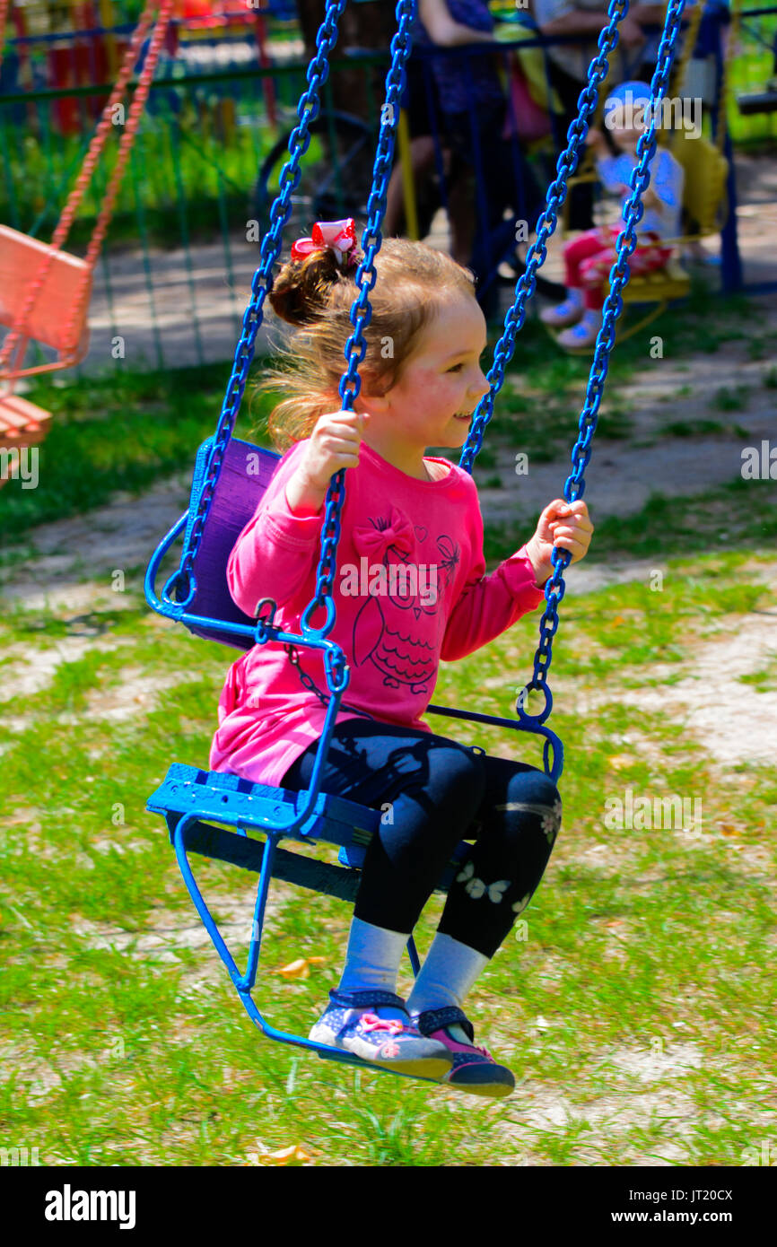 Children ride on the carousel on the children's playground in the city ...