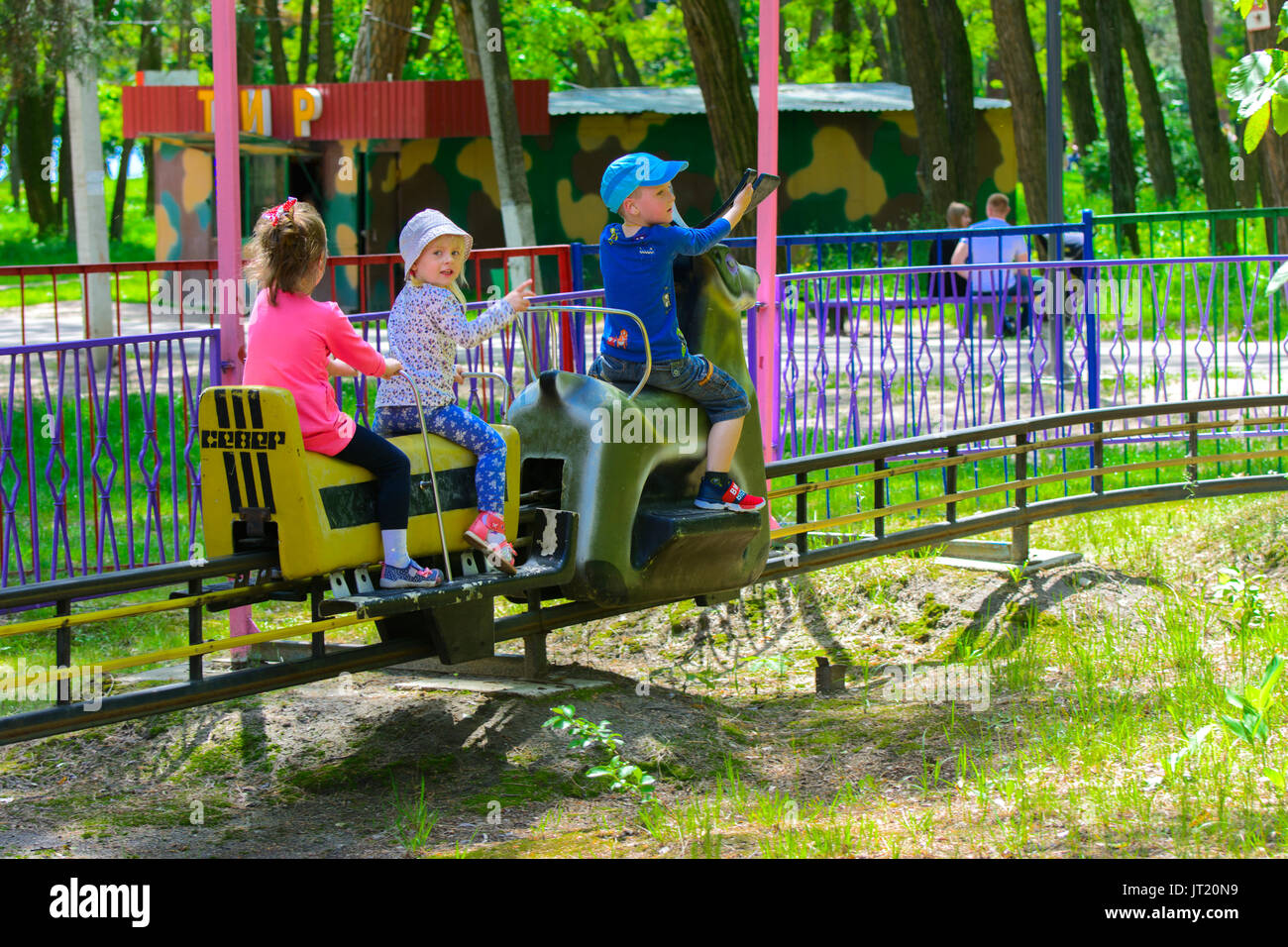 Children ride on the carousel on the children's playground in the city ...