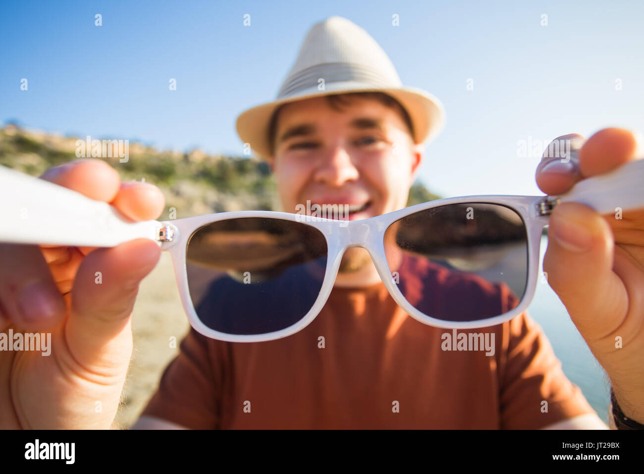 Handsome man puts on hat hi-res stock photography and images - Alamy