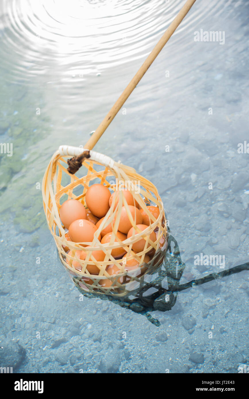 Boil egg in the mineral pool and natural hot water Stock Photo - Alamy