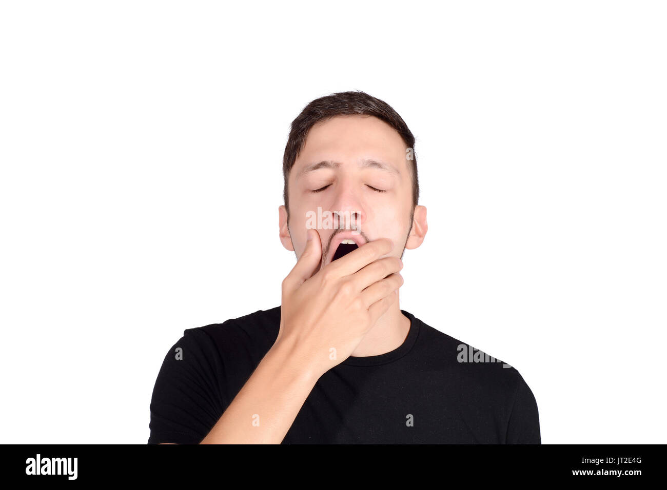 Portrait of a young man yawning. Isolated white background Stock Photo ...