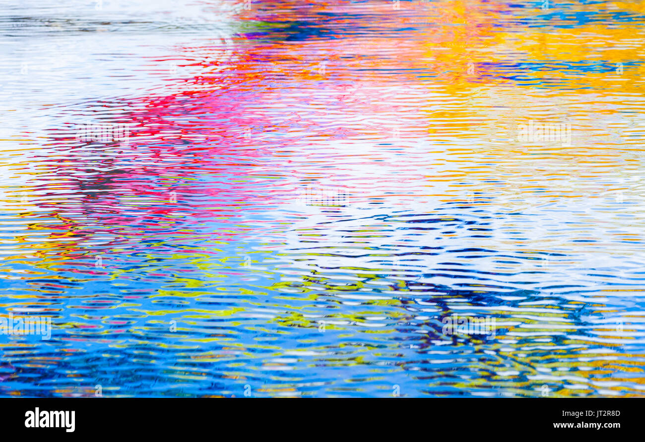 Colorful reflections, ripple water surface. Abstract background photo ...