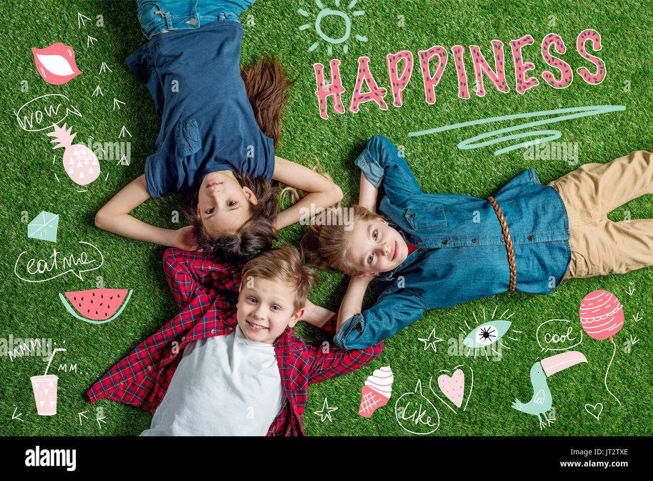 Happy three friends lying on grass Stock Photo - Alamy