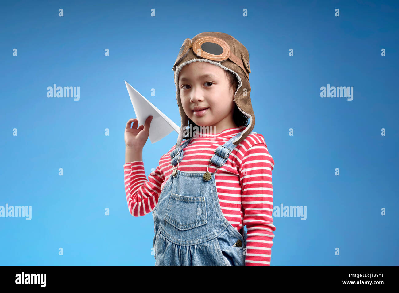 Beautiful asian little girl dreams of becoming a pilot against summer ...