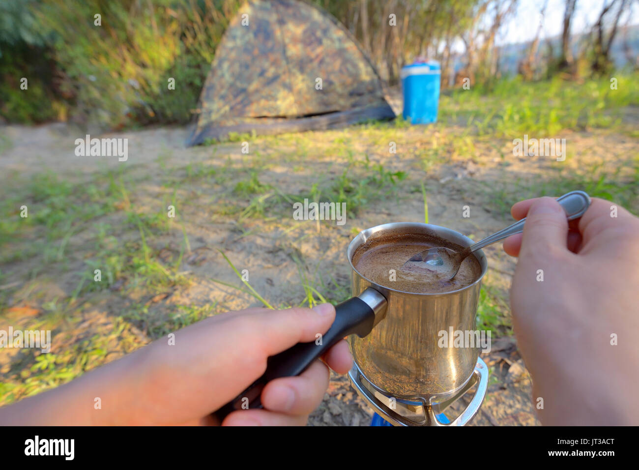 Making coffee on campfire in morning time Stock Photo - Alamy