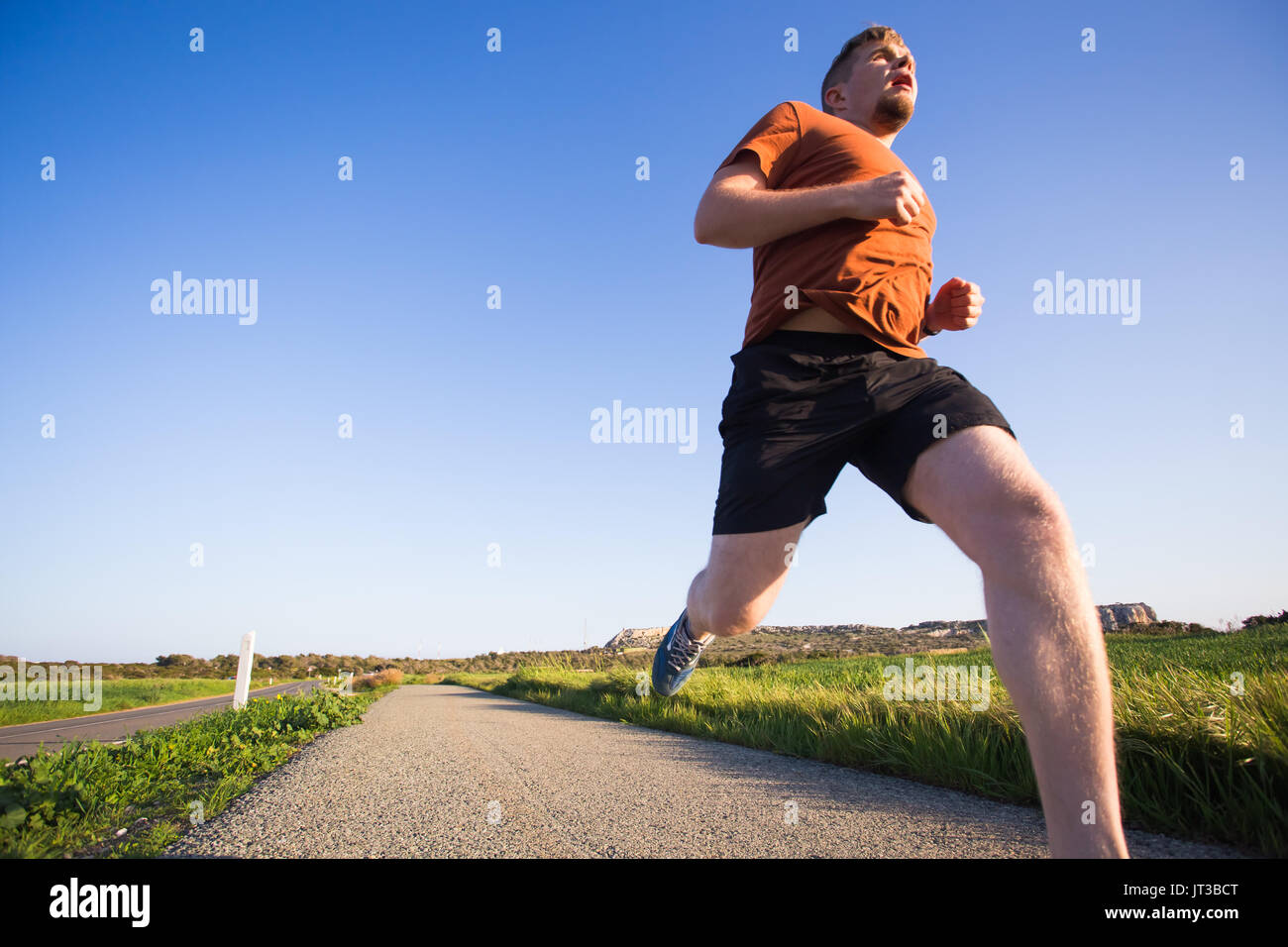 Athletic young man running in the nature. Healthy lifestyle Stock Photo ...