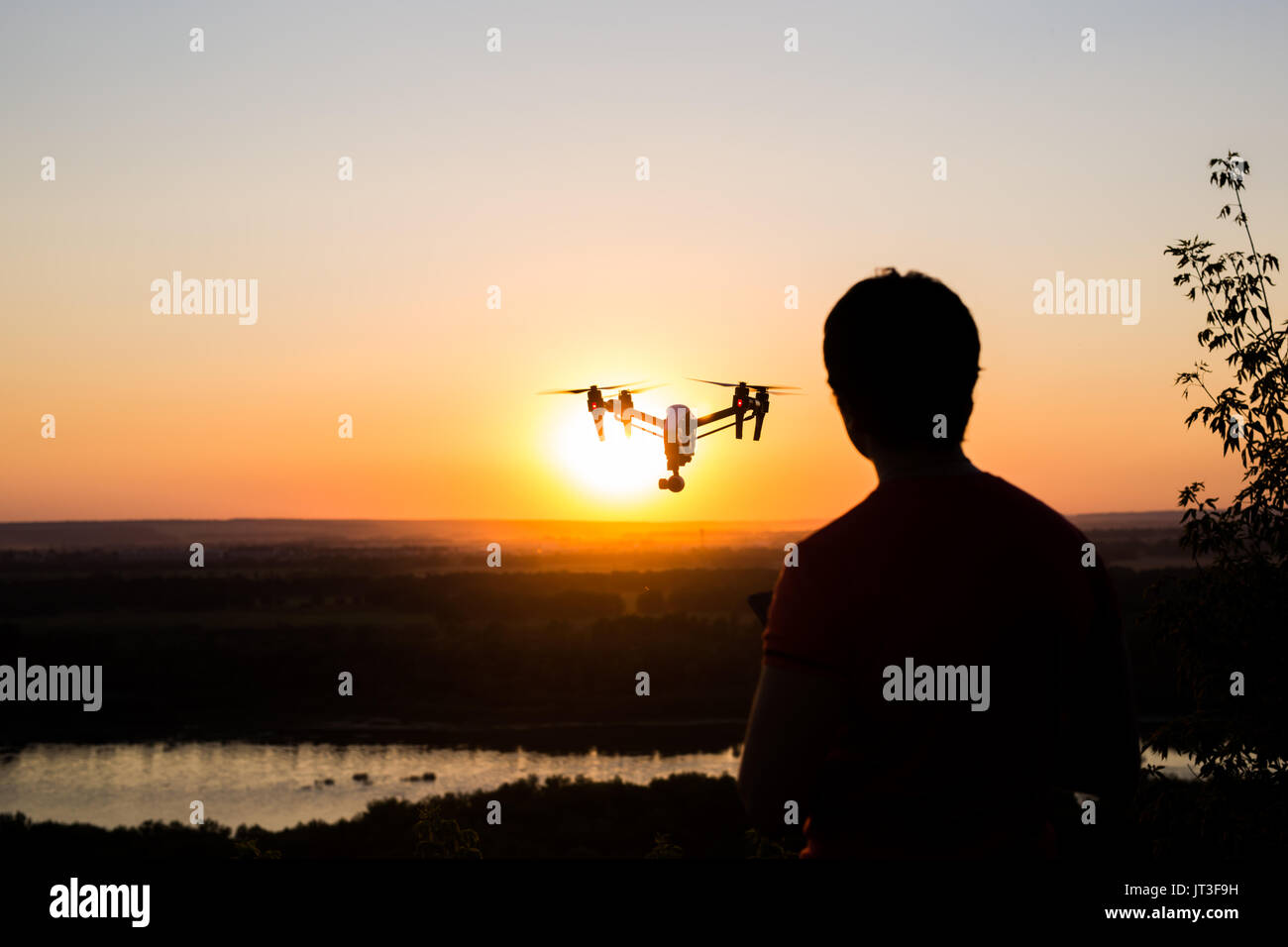 quadrocopter drone with remote control. Dark silhouette against ...